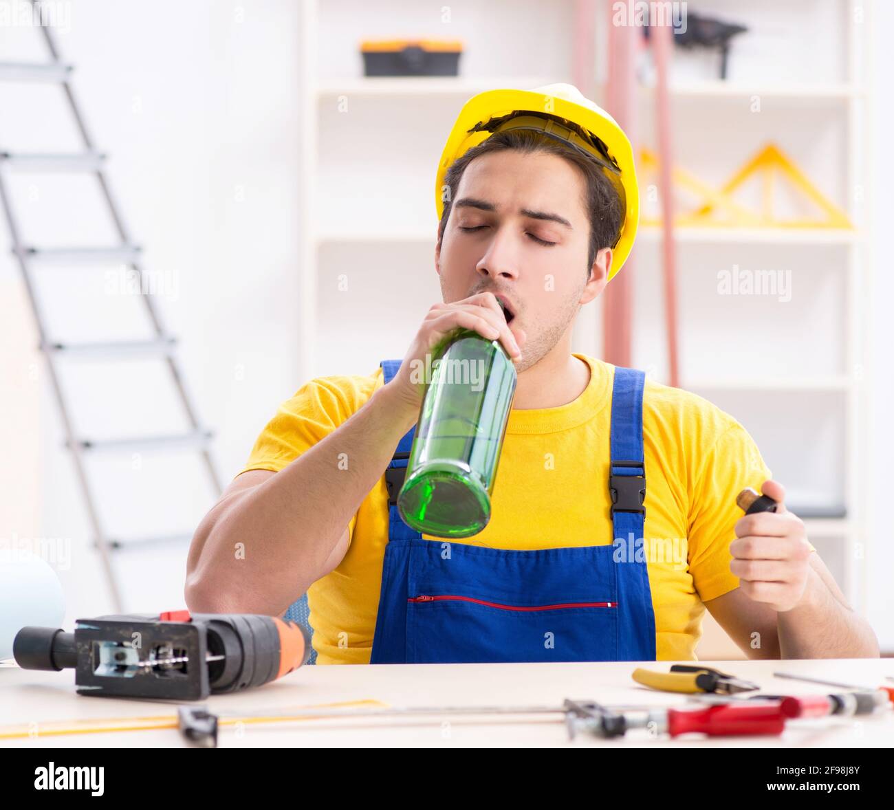 The drunk engineer working in the workshop Stock Photo - Alamy
