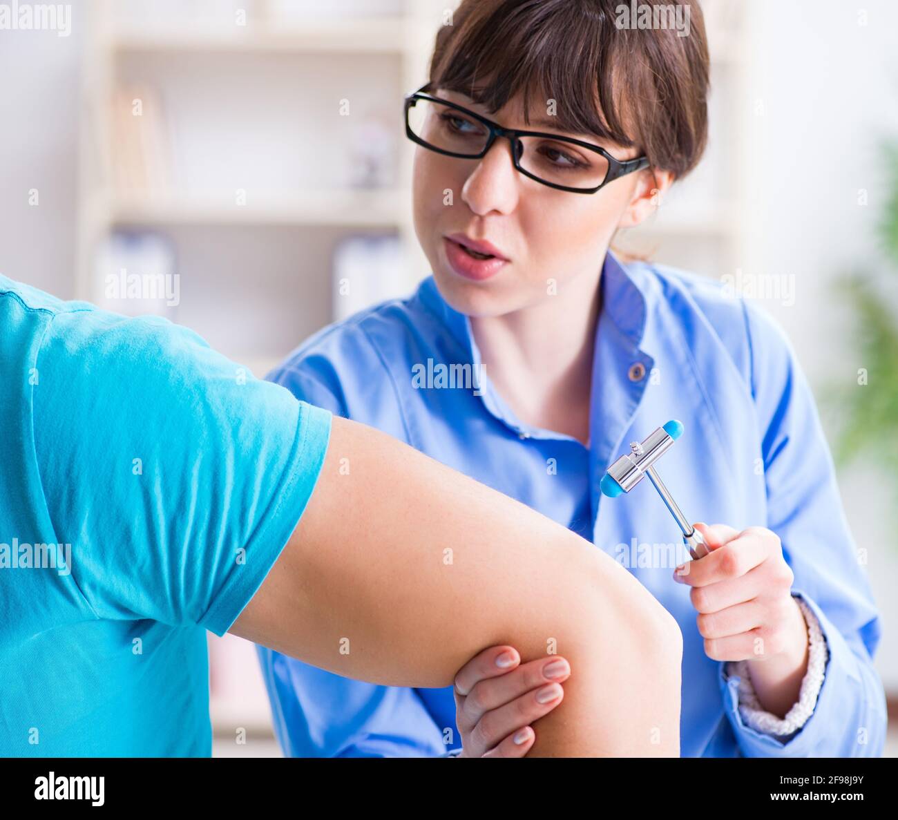 The doctor checking nerve reflexes with hammer Stock Photo - Alamy