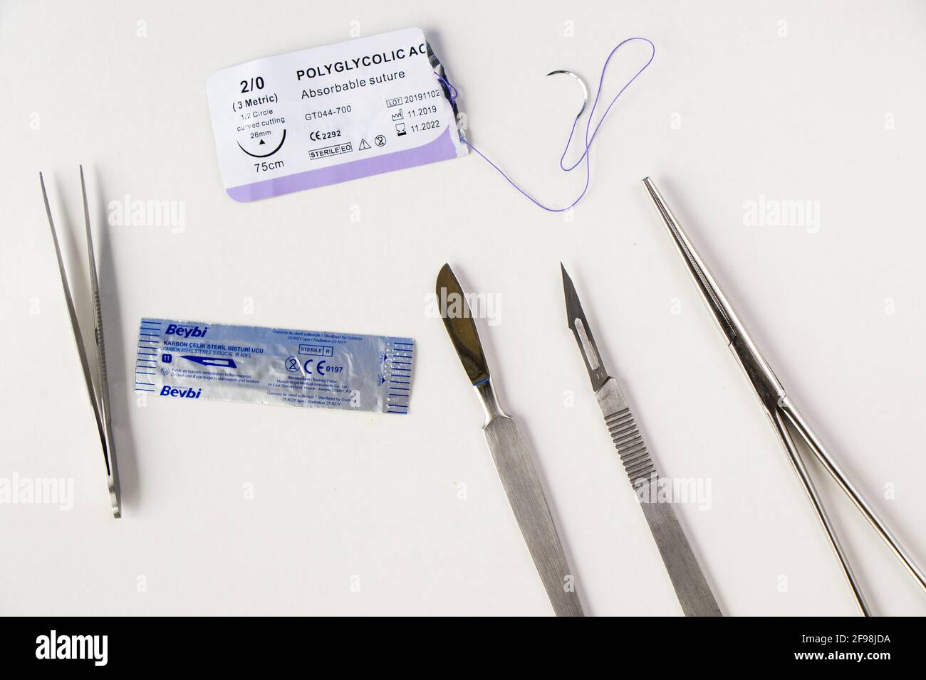 Top view of a surgical needle and thread with a dissection kit on a ...