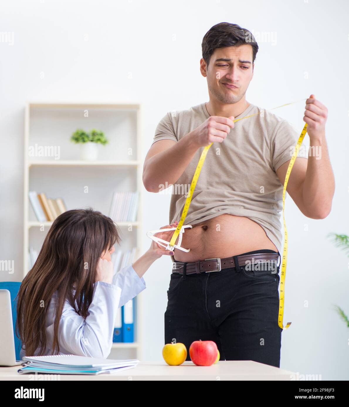The doctor dietician giving advices to fat overweight patient Stock ...