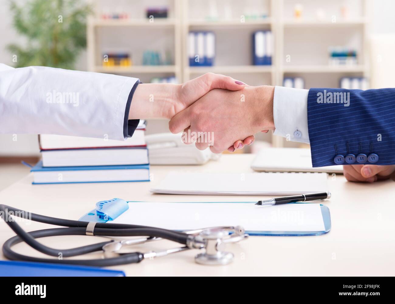 The man signing medical insurance contract Stock Photo - Alamy