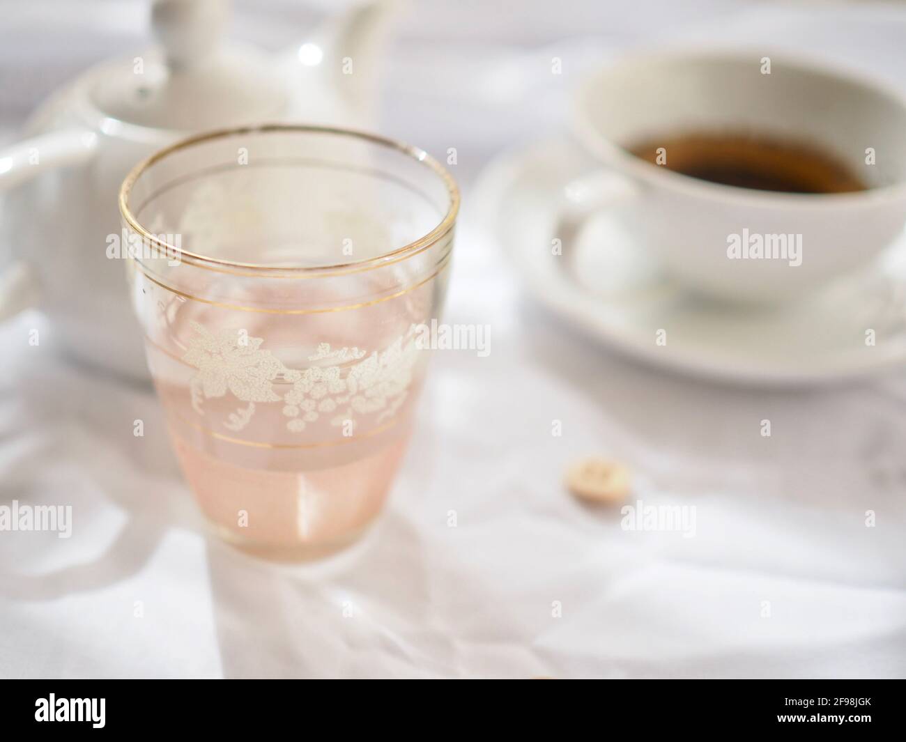 Pink glass with tea pot and tea on a bright white background Stock ...