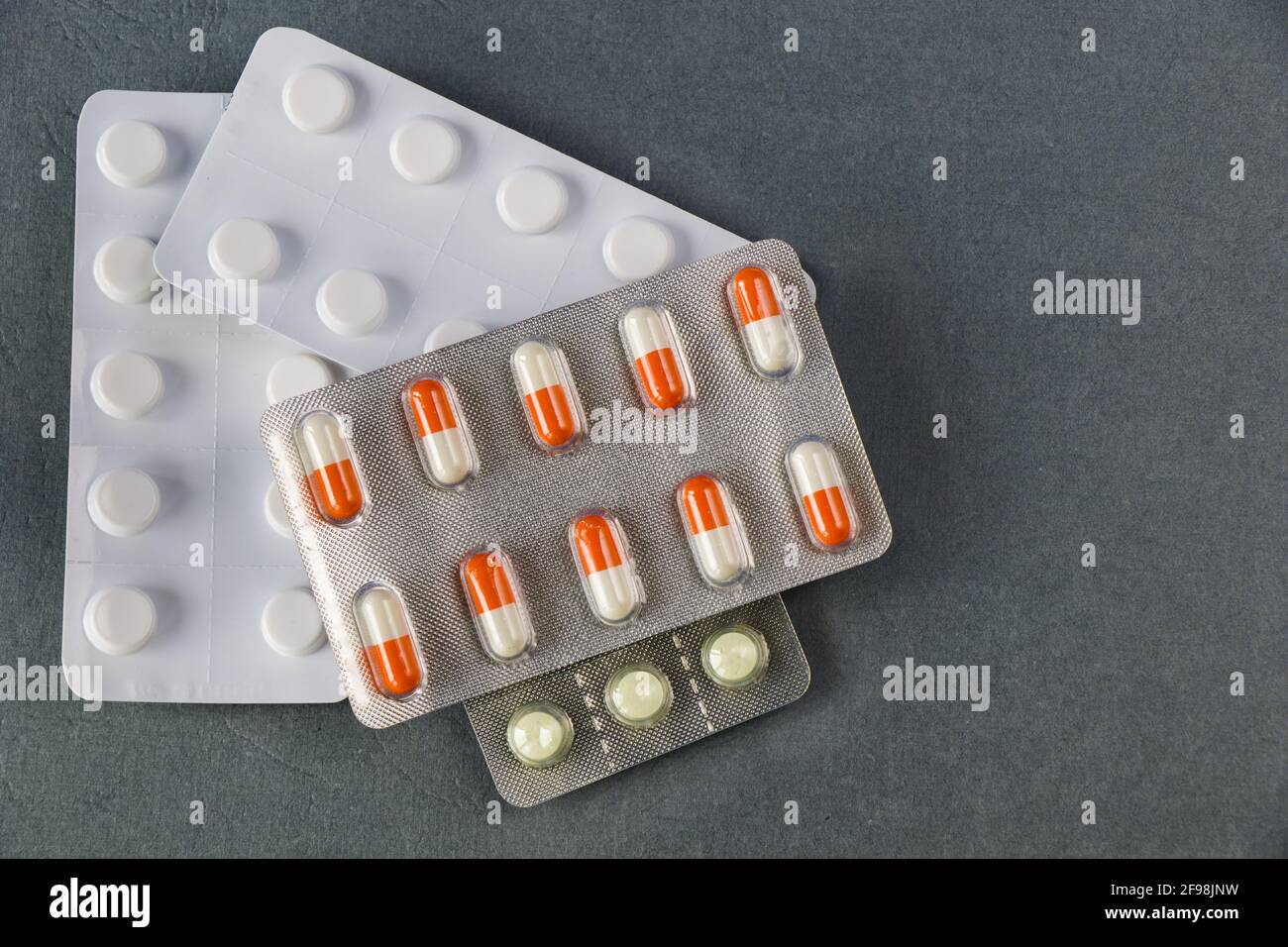Top view of tablets and pills on a gray surface Stock Photo - Alamy