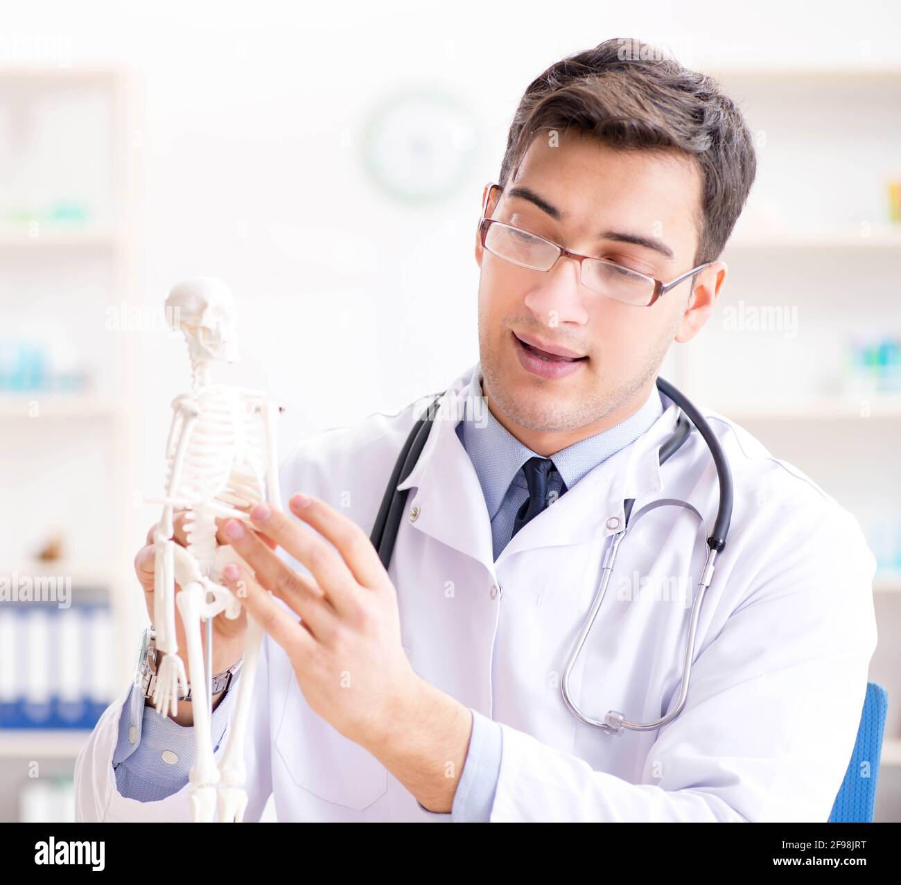 The doctor explaining human body on skeleton Stock Photo - Alamy