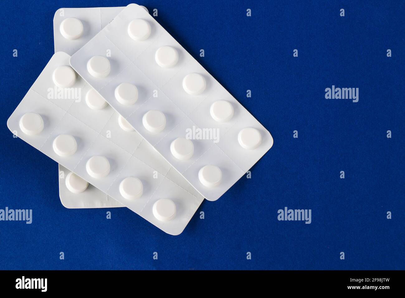 Top view of tablets on a dark blue surface Stock Photo - Alamy