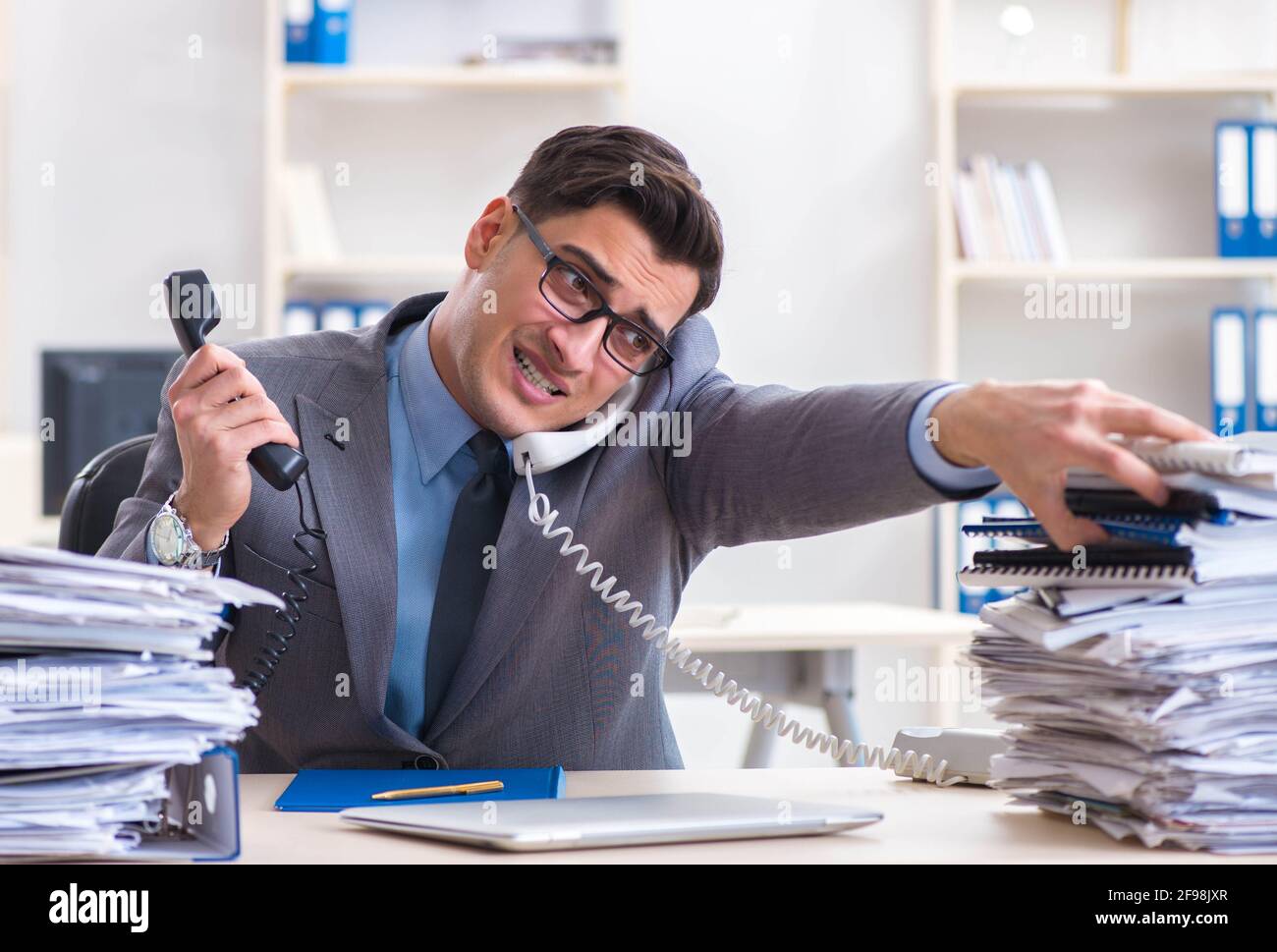 The desperate sad employee tired at his desk in call center Stock Photo ...