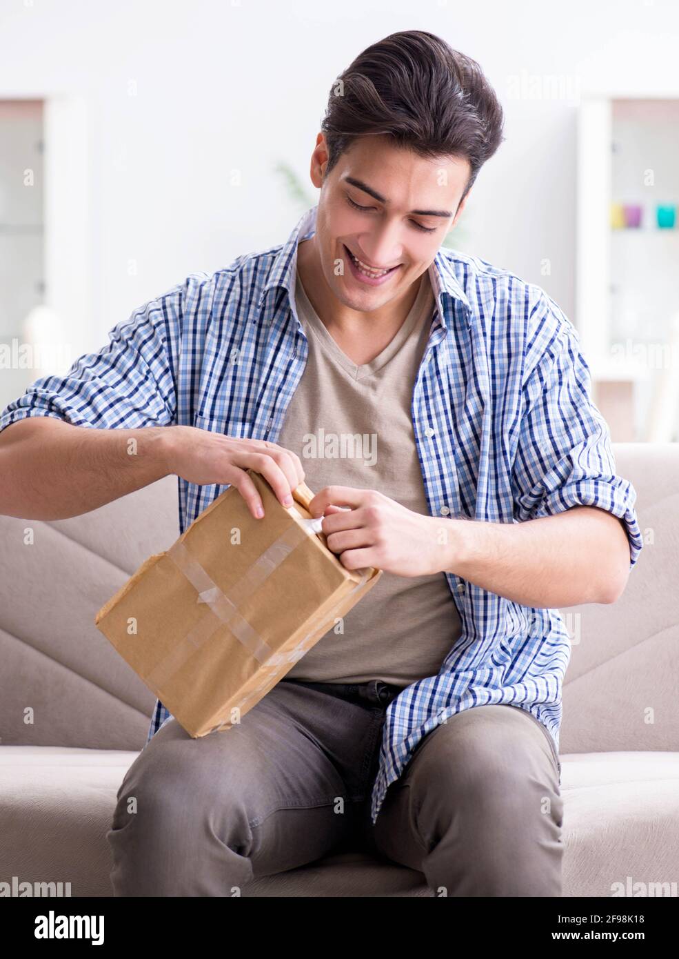 The man receiving parcel at home Stock Photo - Alamy