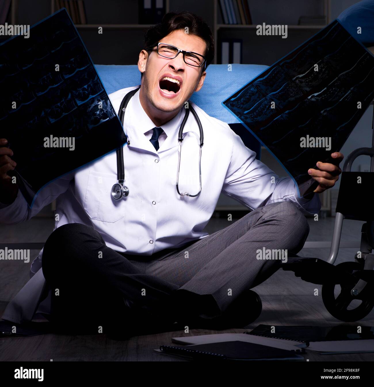 The doctor working night shift in hospital after long hours Stock Photo ...