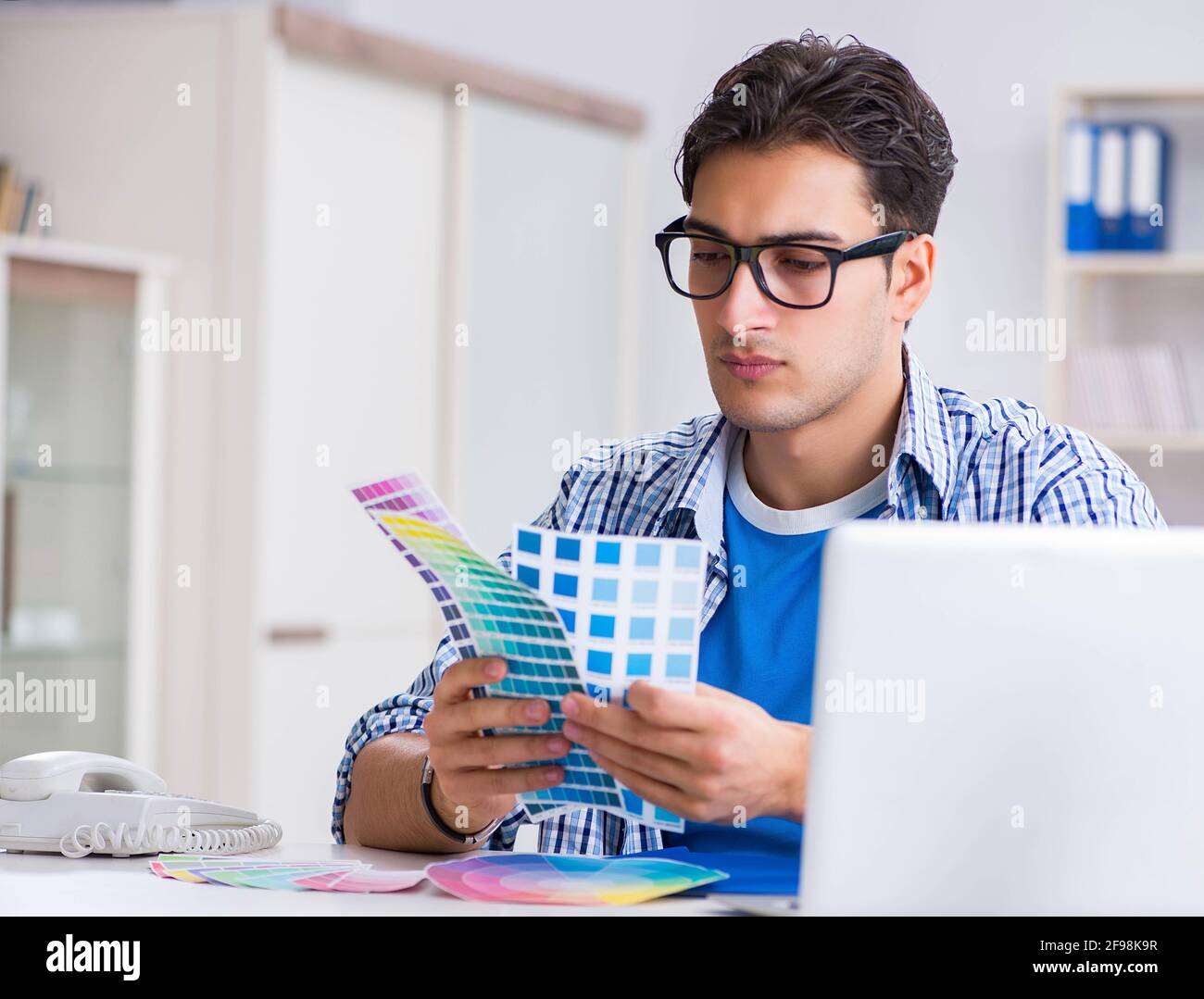 The young designer working on new project and choosing colours Stock ...
