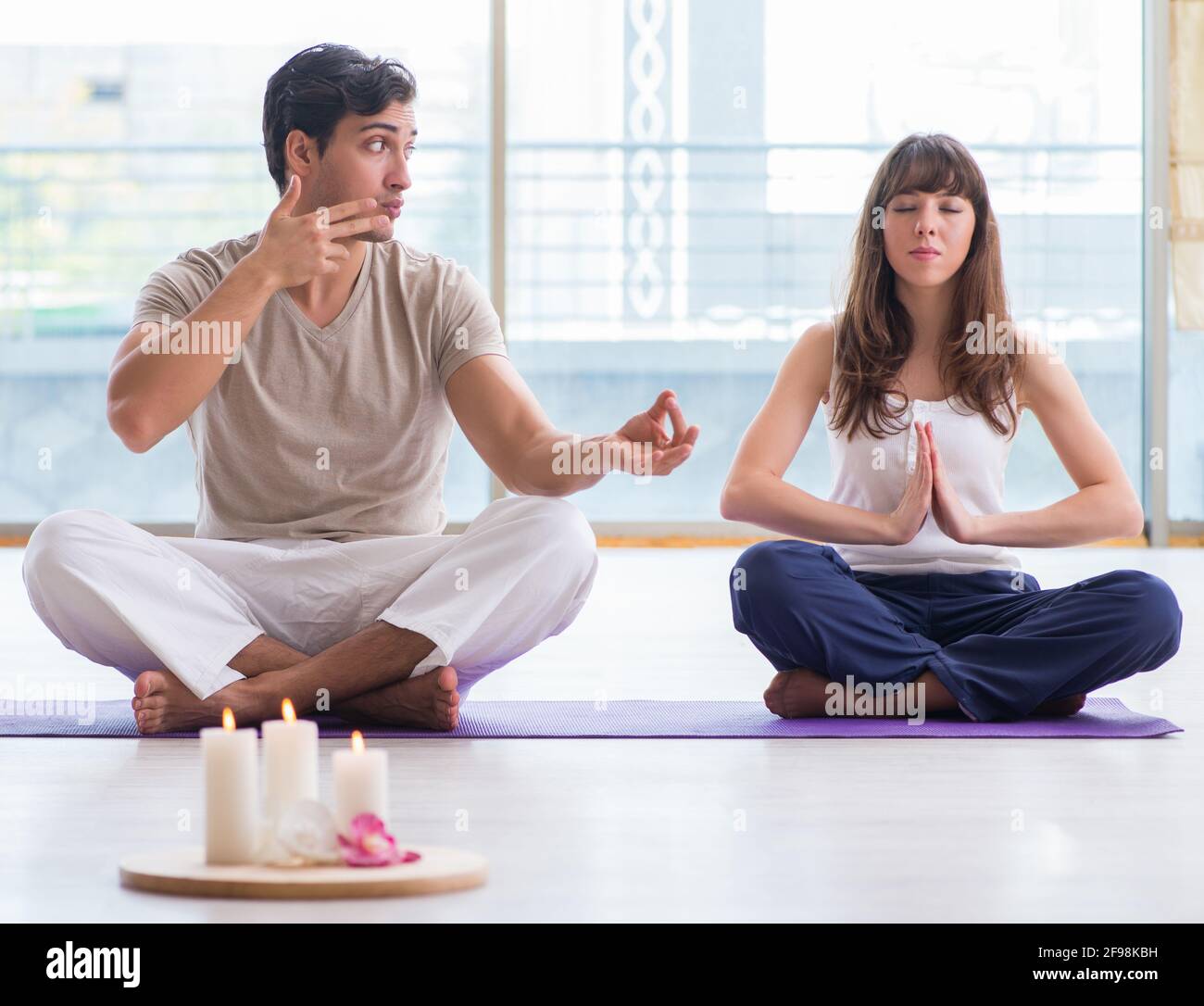 The personal coach helping during yoga session Stock Photo - Alamy