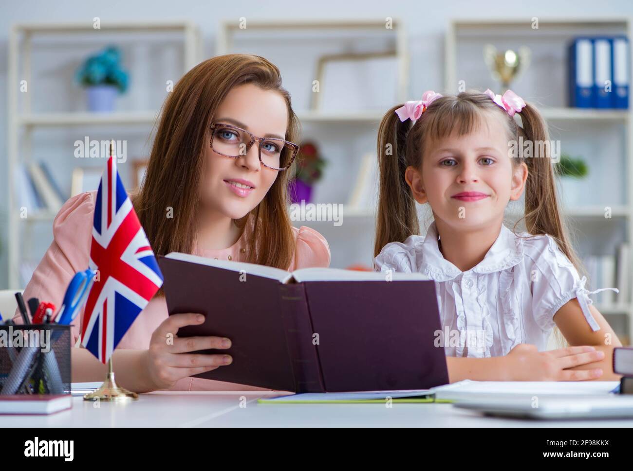 The young girl learning english with teacher Stock Photo - Alamy