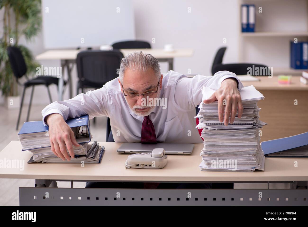 Experienced businessman employee and too much work in the office Stock ...