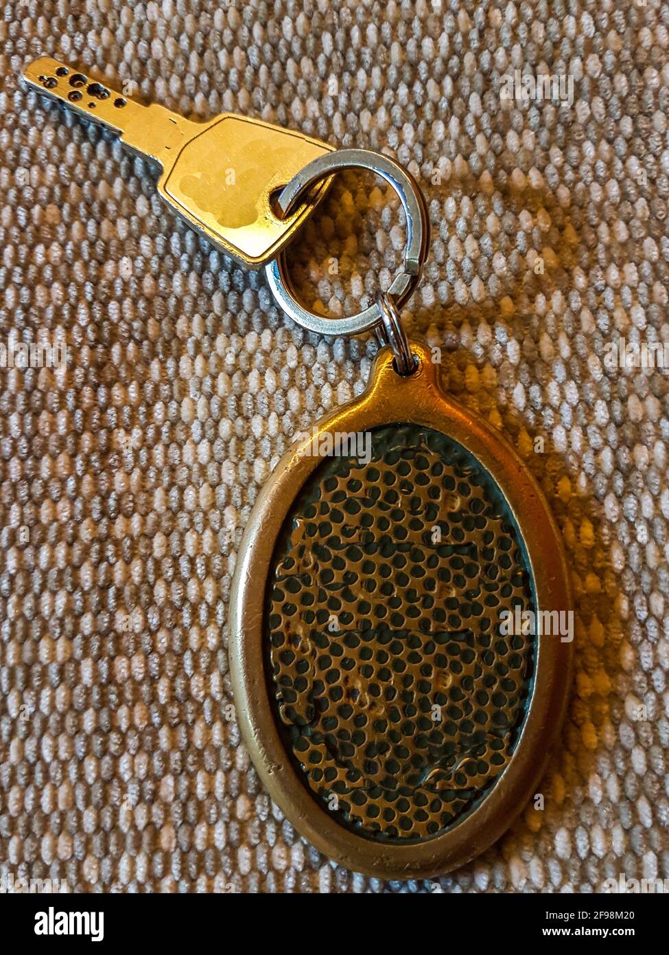 Vertical shot of key with a keychain on the table Stock Photo - Alamy