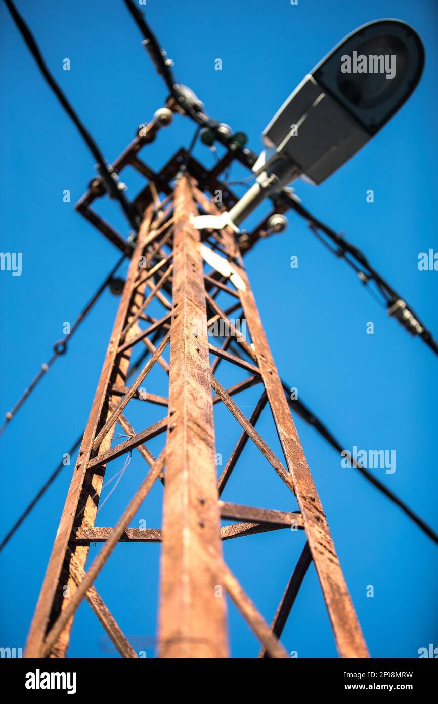 Low angle shot of an old rusty metal electric post with a street lamp ...