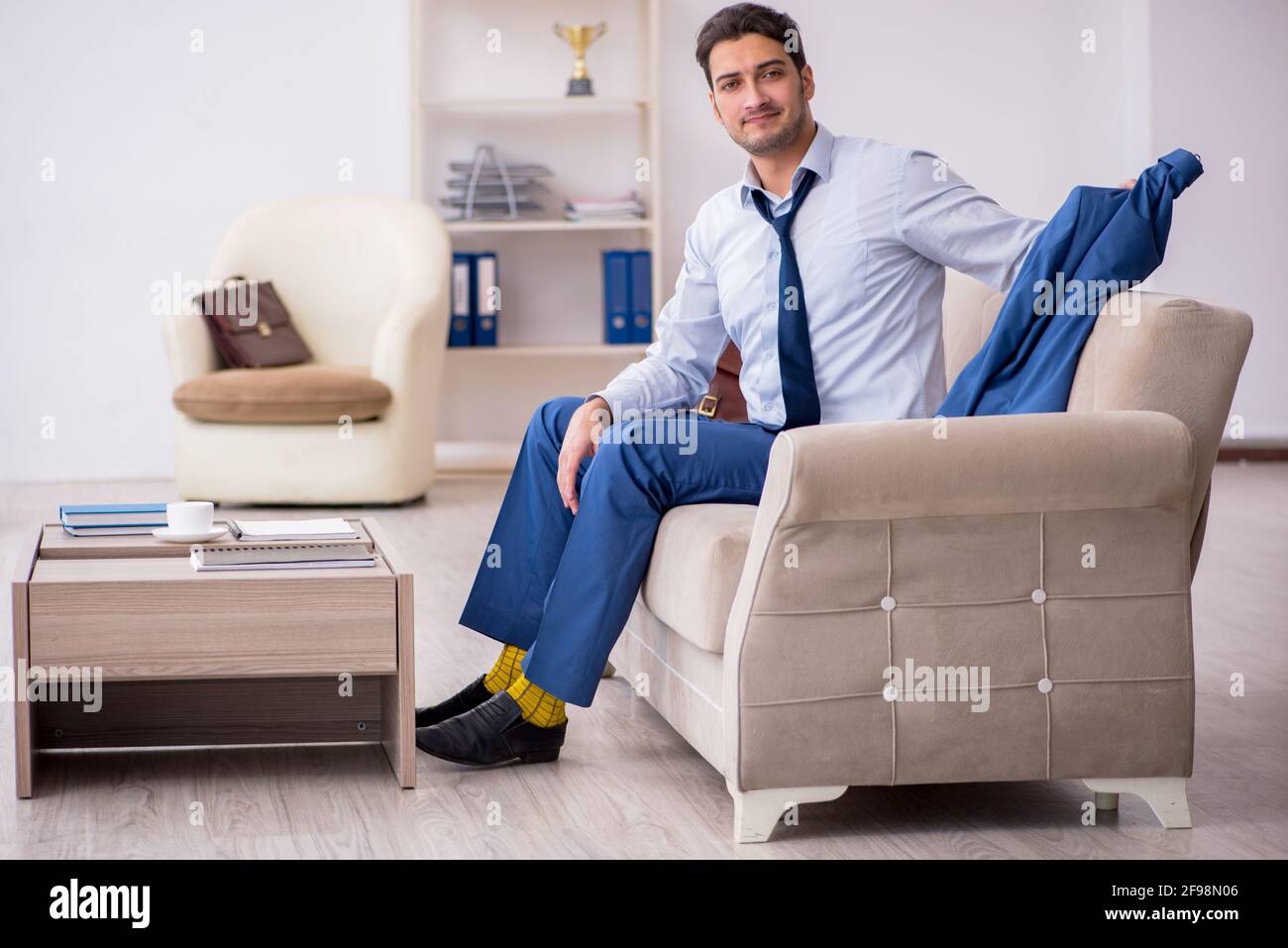Young male employee waiting for business meeting Stock Photo - Alamy