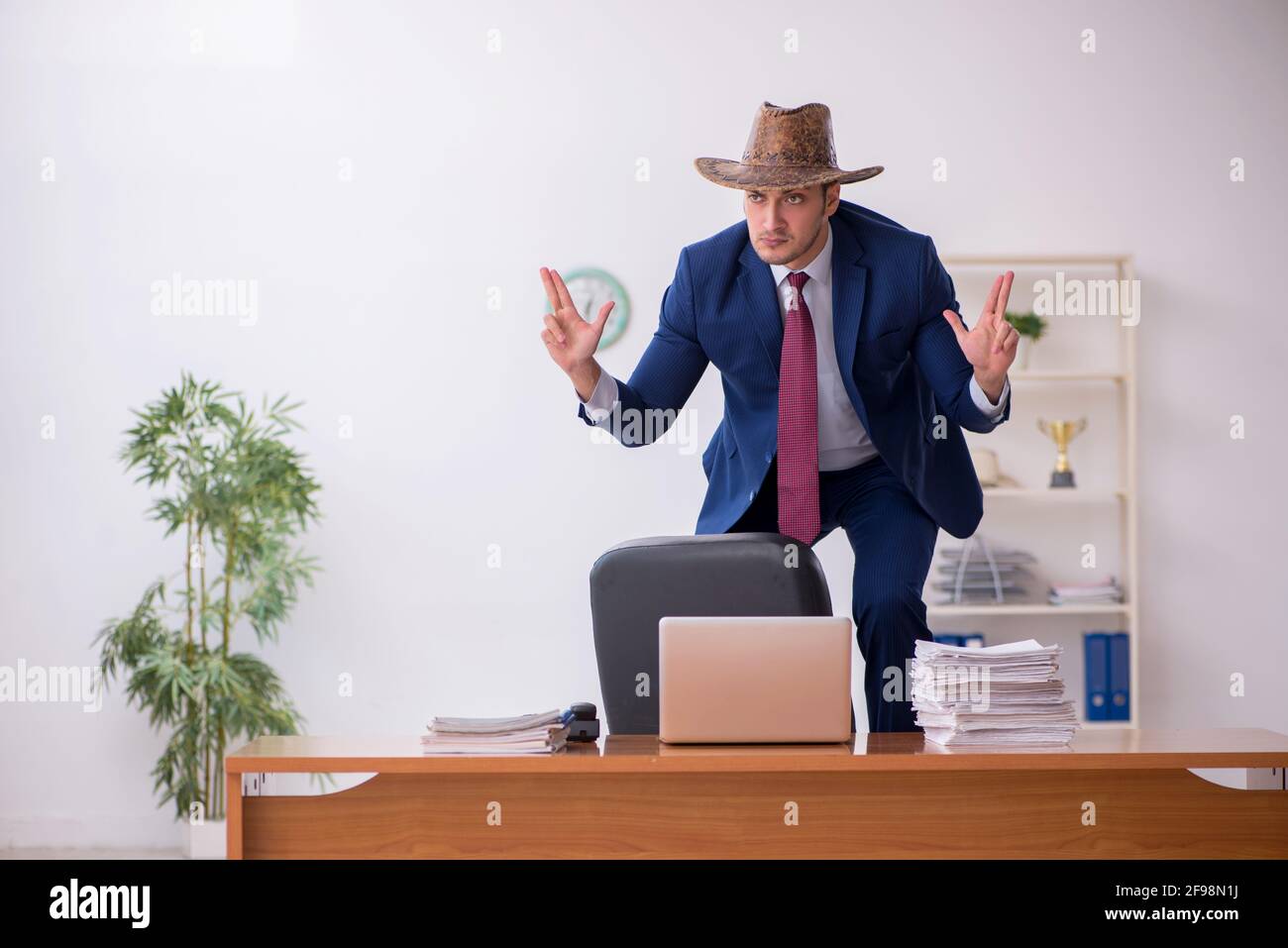 Young cowboy employee working at workplace Stock Photo - Alamy