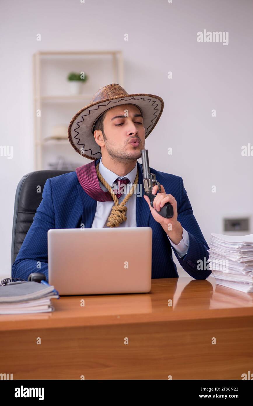 Young cowboy employee working at workplace Stock Photo - Alamy