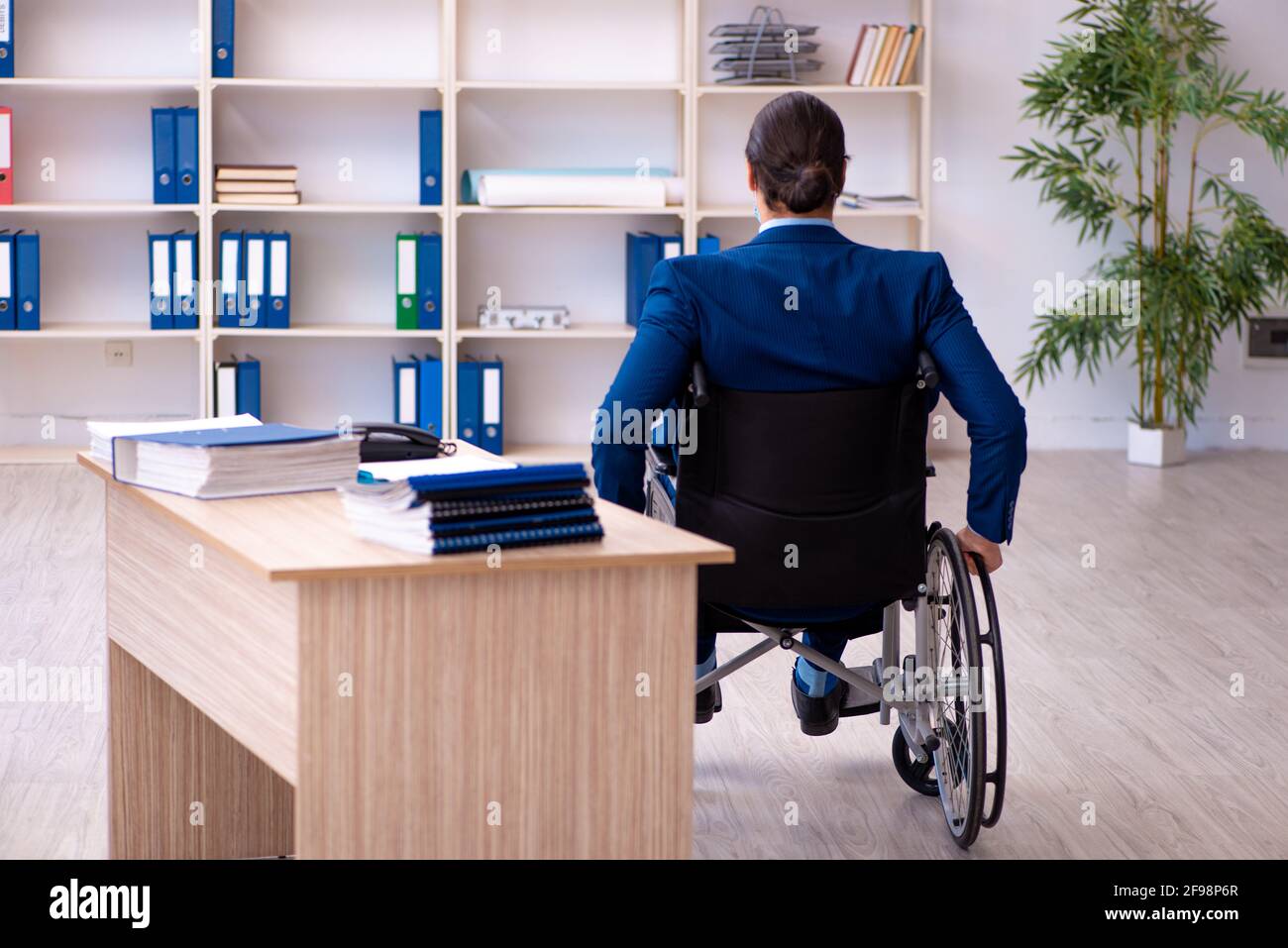 Young male disabled employee working in the office Stock Photo - Alamy