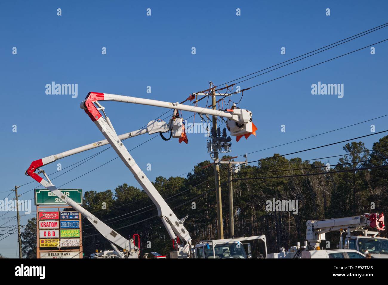Columbia County, Ga USA - 02 24 21: Powerline workers in lift buckets ...