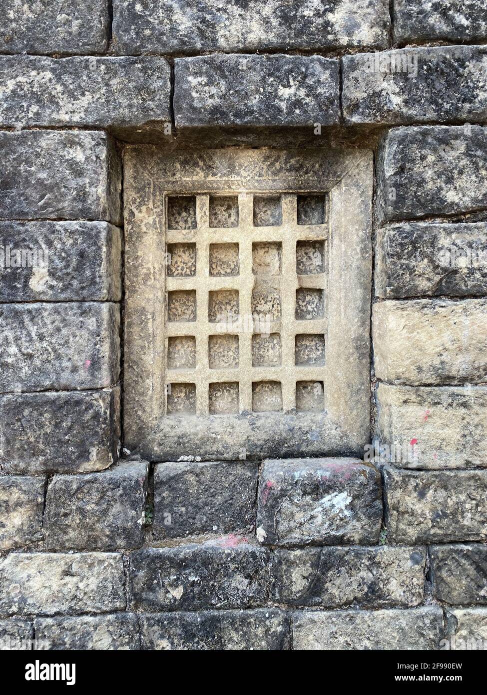 Vertical shot of an old wooden locked window on a stone wall Stock ...