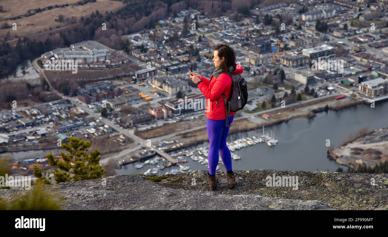 Adventurous Girl Hiking on top of a Peak Stock Photo - Alamy
