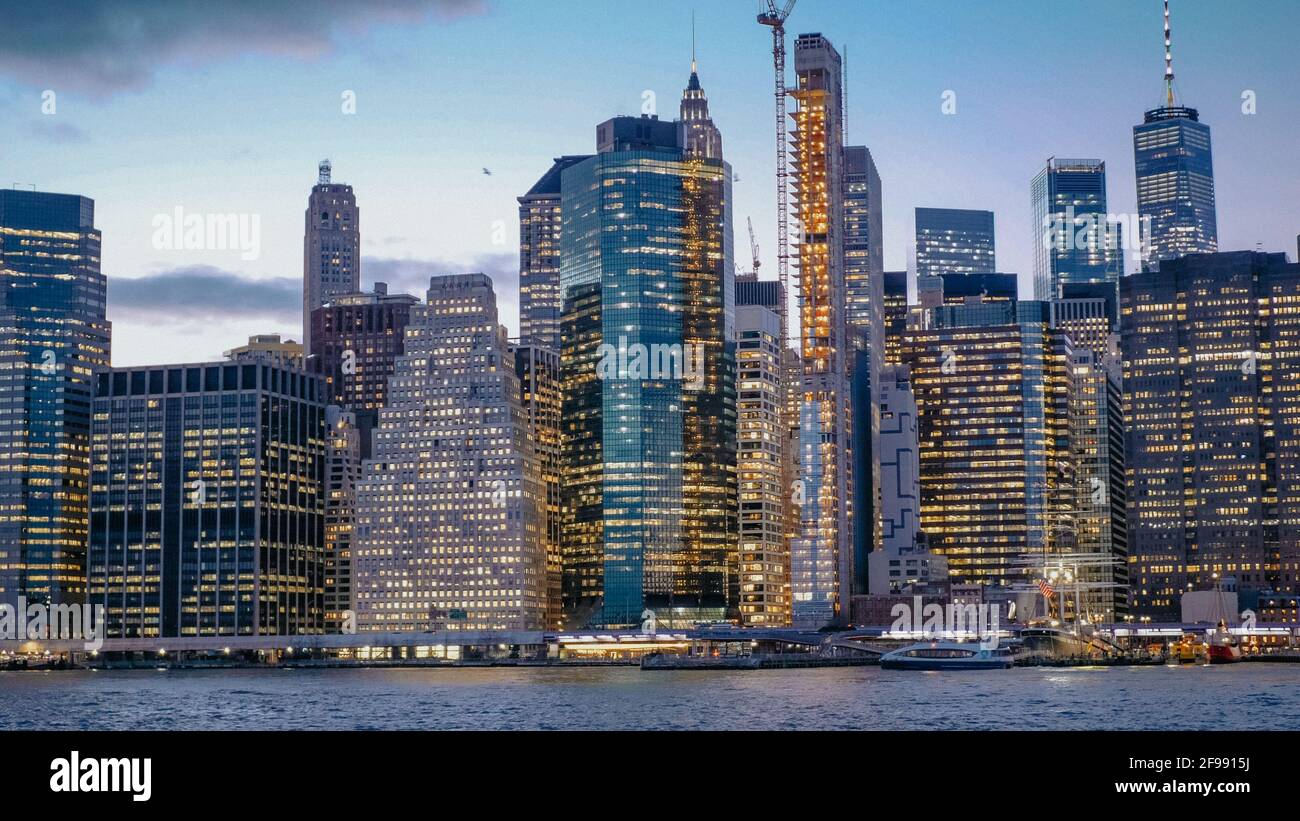 Beautiful Manhattan skyline and New York city lights in the evening ...