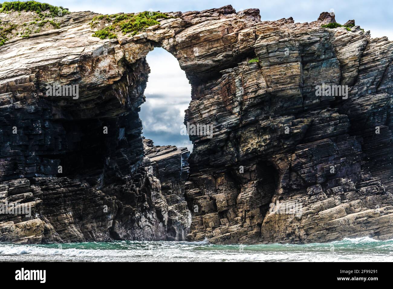 Beautiful shot of the natural stone arch of the Catedrales beach in ...