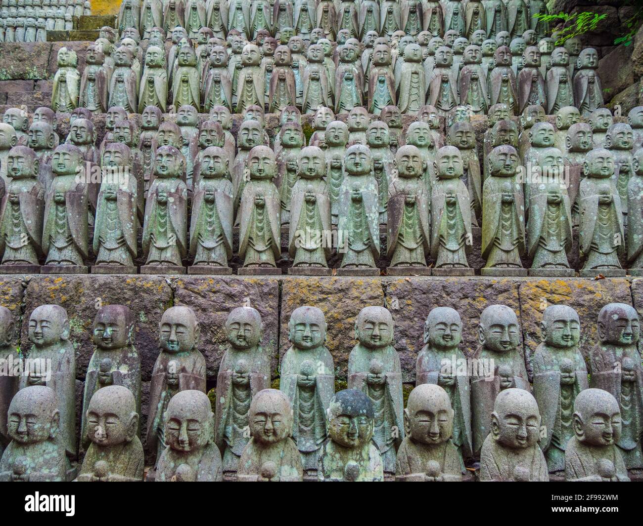 Small praying monk statues at Hase Dera Temple in Kamakura Stock Photo ...
