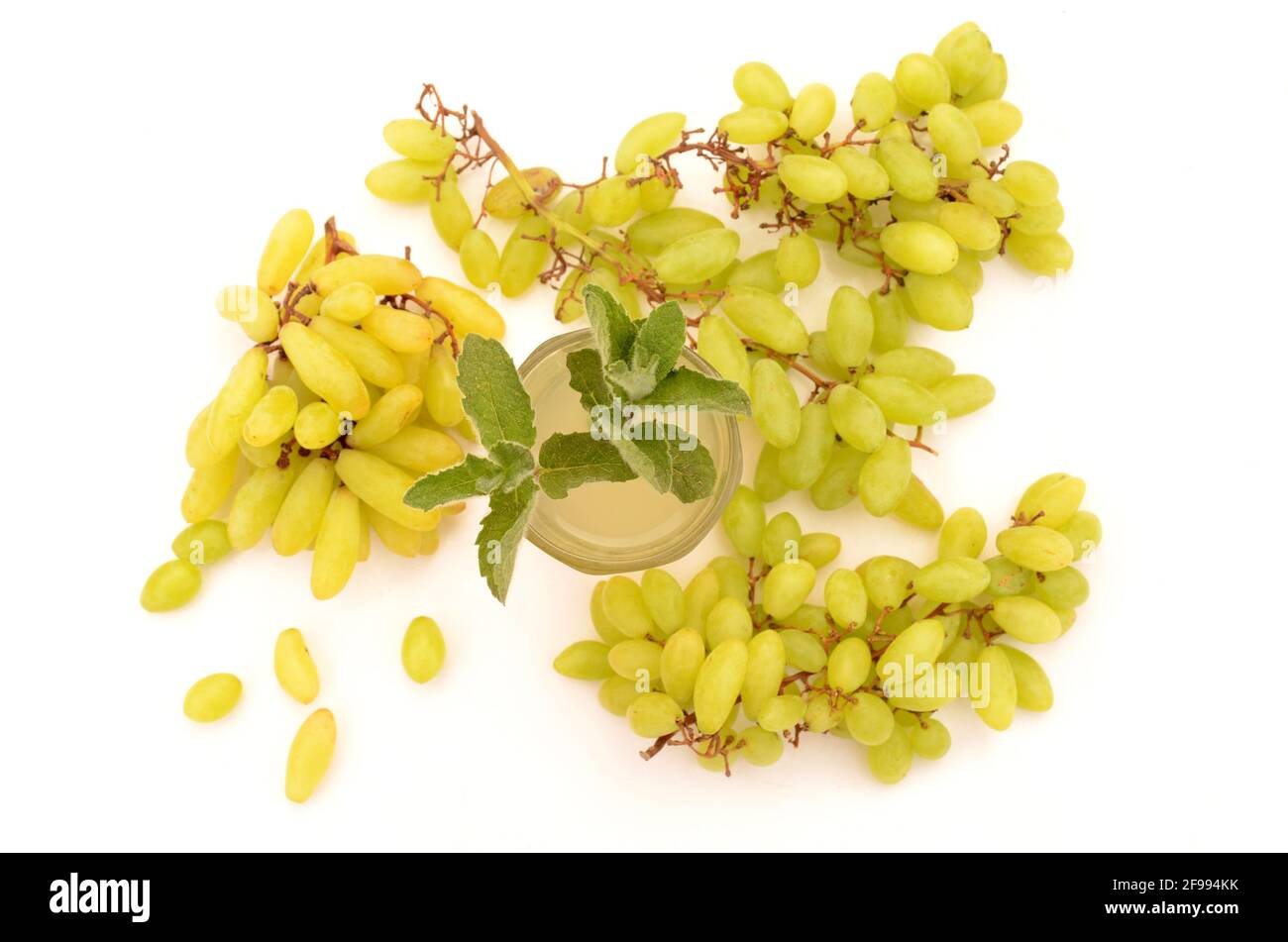 Top view shot of grapes juice with a bunch the green ripe grape, mint ...