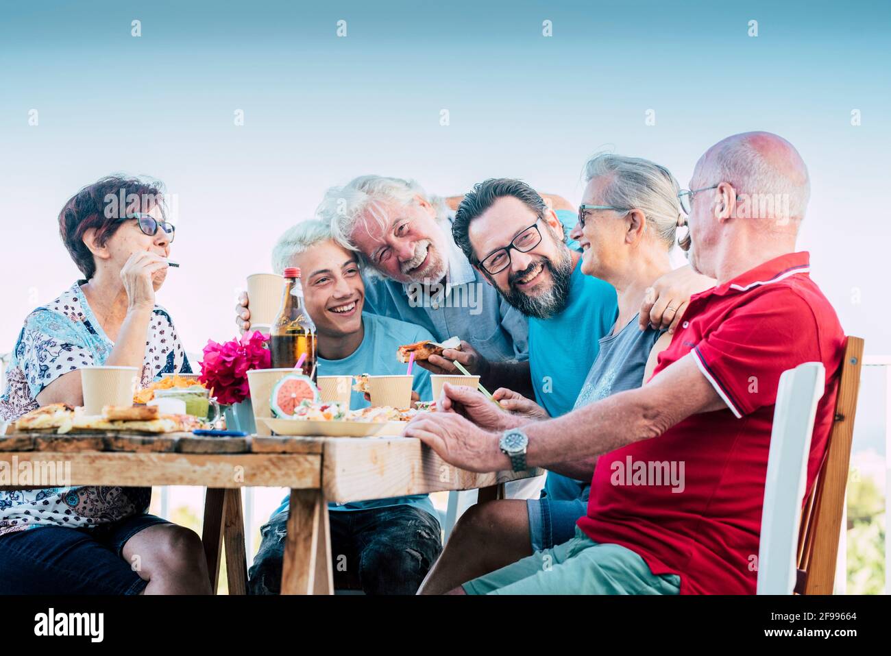 Group young people around table hi-res stock photography and images - Alamy