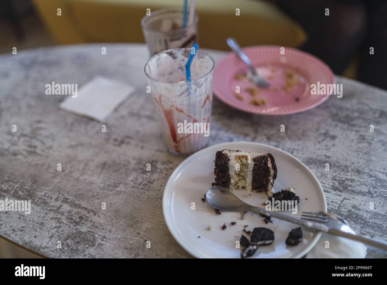 Soft focus of a messy table with plates and glasses and plates left by ...