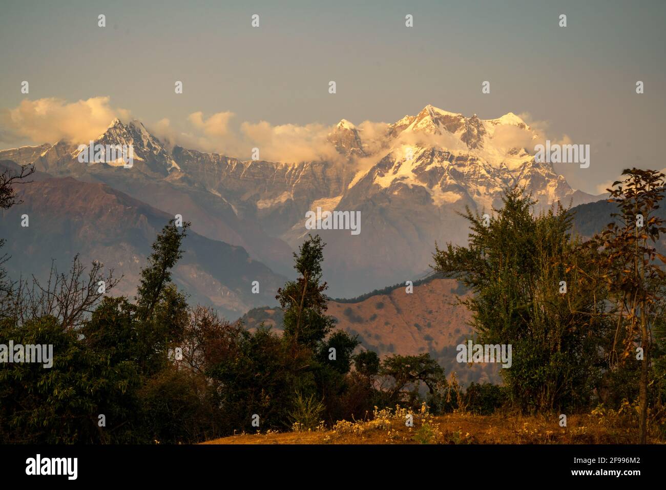 Golden sun rays falling on snow cladded Chaukambha peaks of Gangotri ...