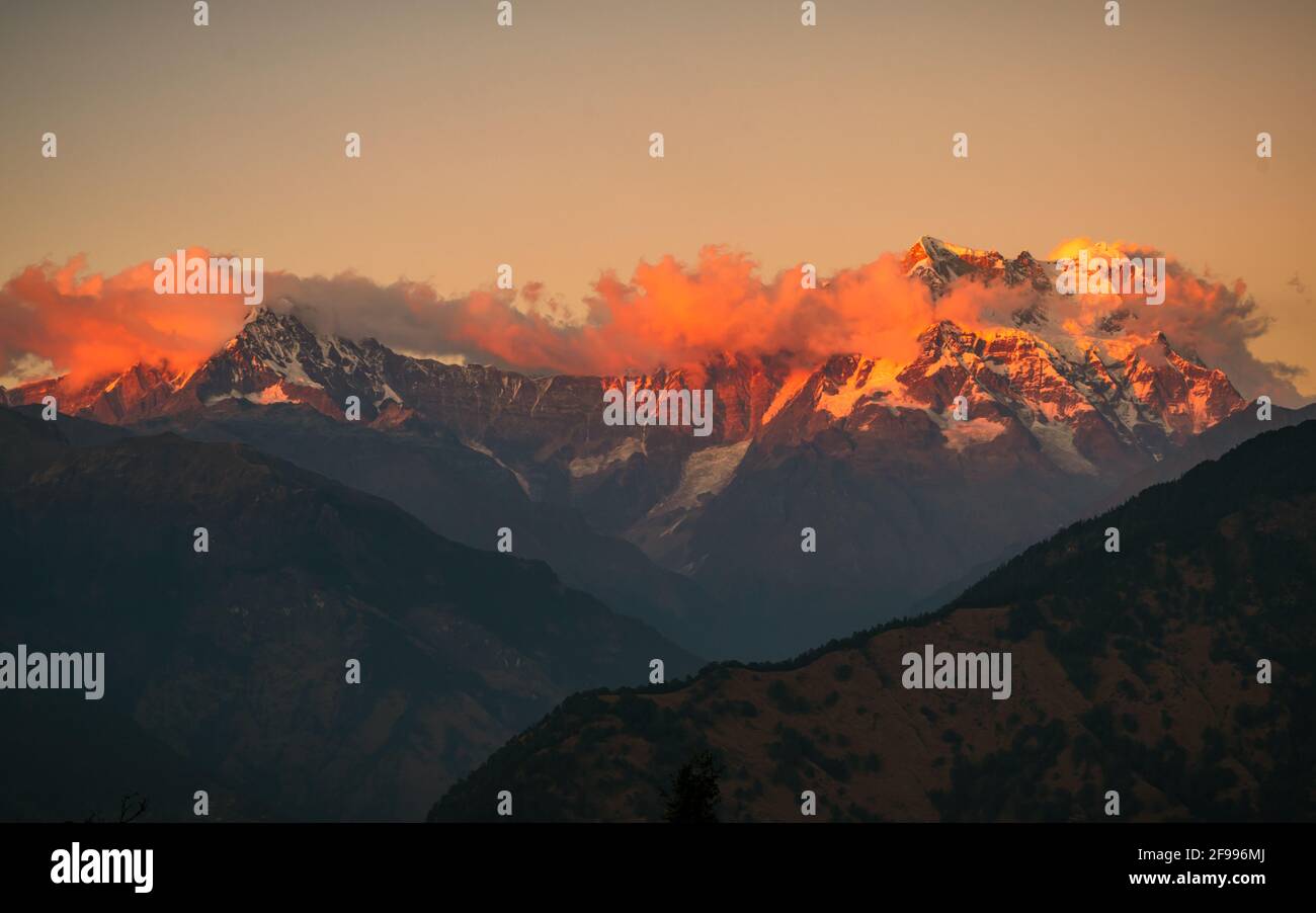 Golden sun rays falling on snow cladded Chaukambha peaks of Gangotri ...