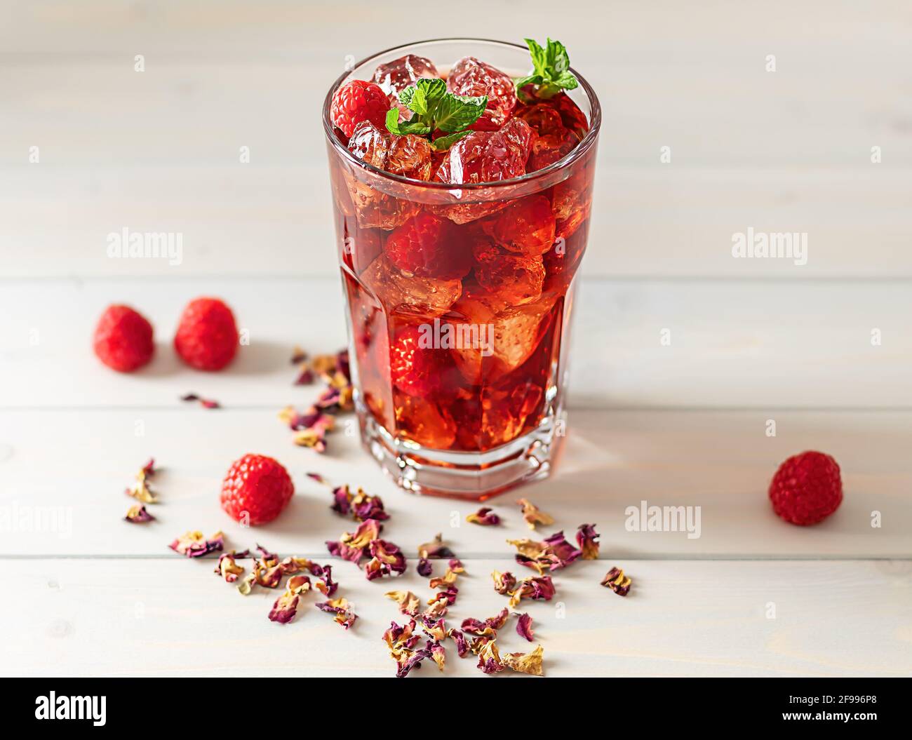 Cold Brew Hibiscus Ice Tea with raspberry and mint. Selective focus ...