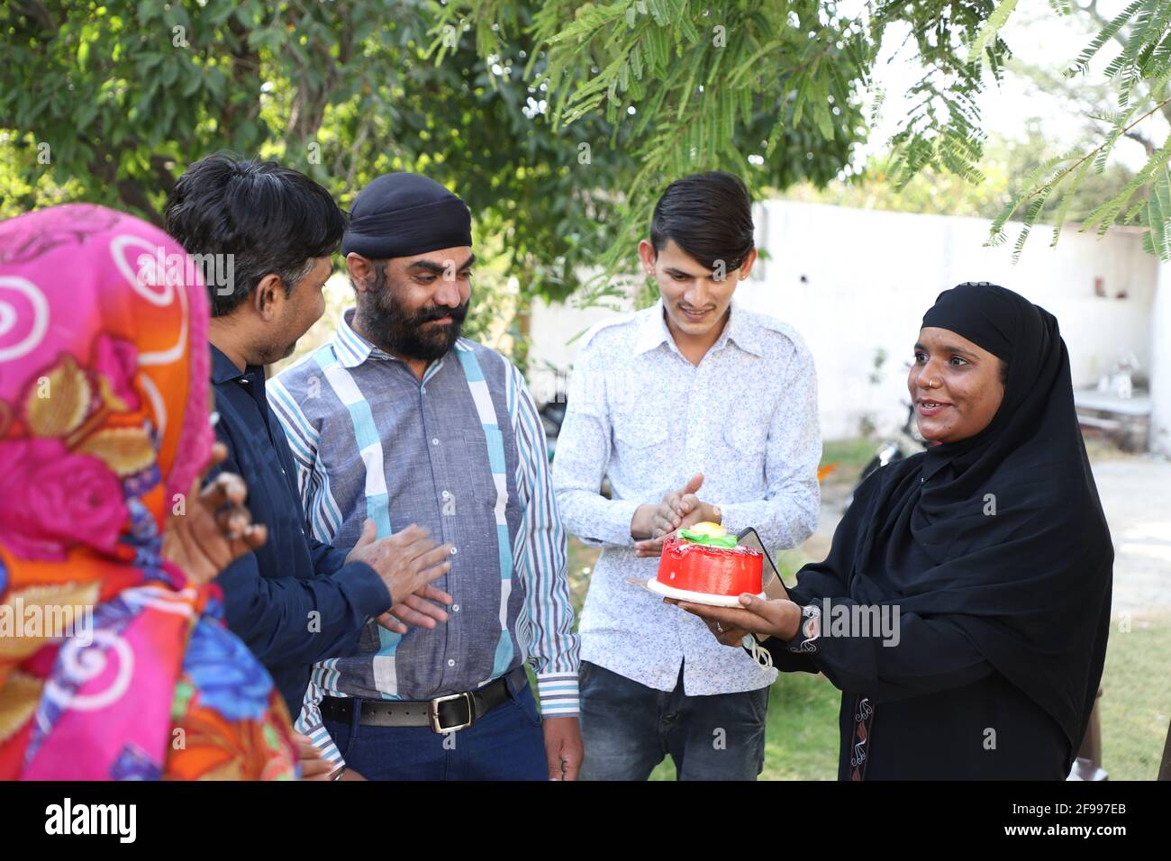 Closeup of a happy Indian family celebrating a birthday outdoors Stock Photo - Alamy