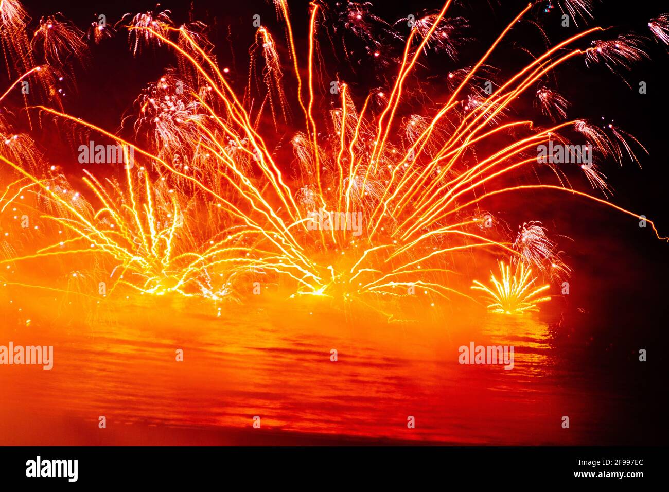 Scenic view of fireworks illuminates the water with a dazzling display ...