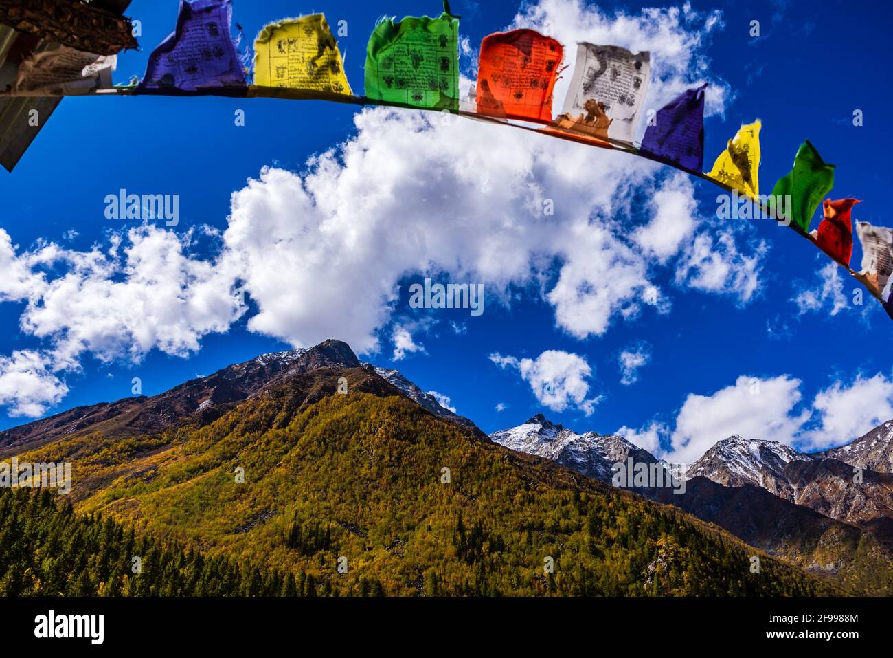 Colorful prayer flags flying in winds with Himalayas mountains in ...
