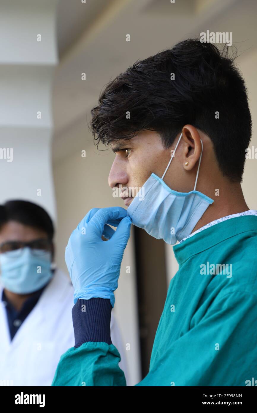 Vertical shot of an Indian doctor with medical uniform and mask on the ...