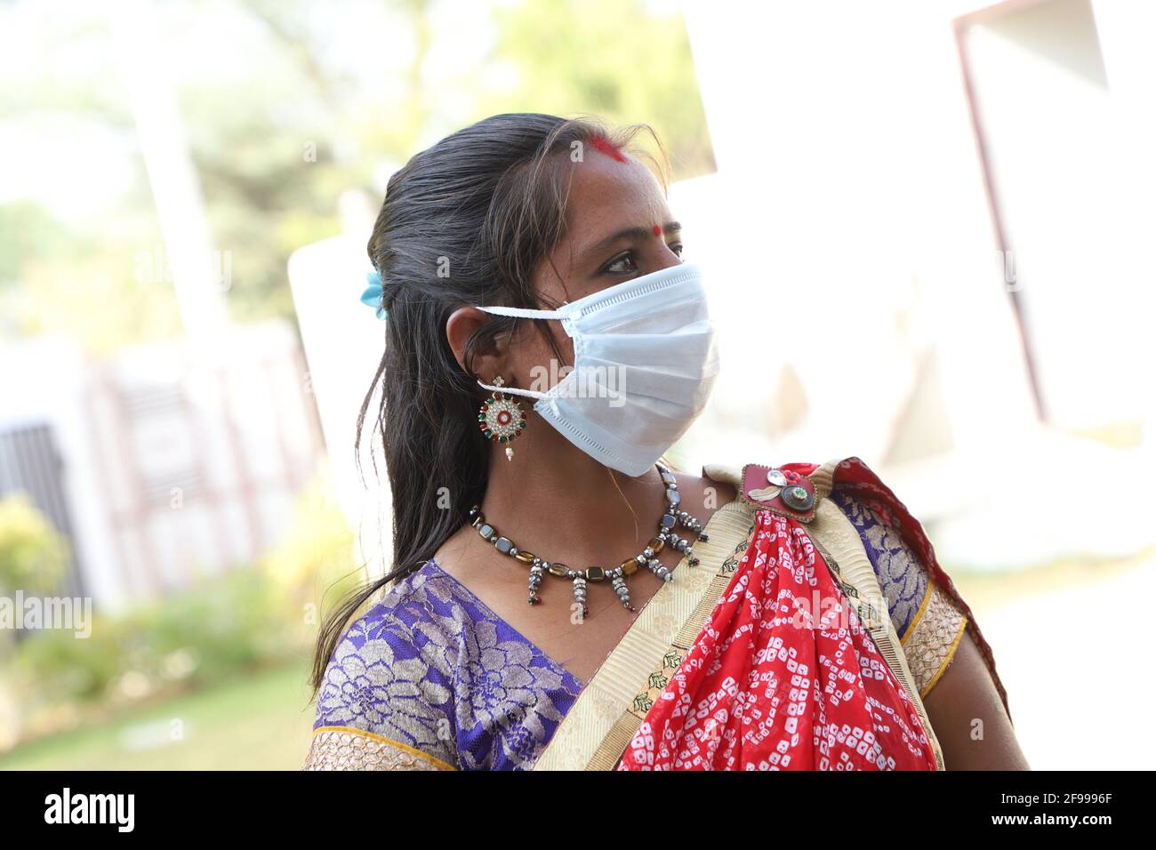 Closeup shot of an Indian woman with traditional dress and mask Stock ...