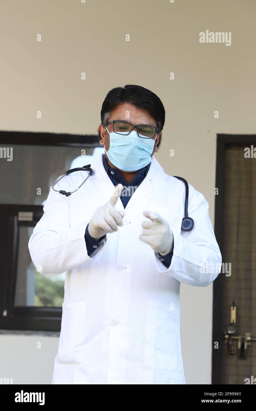 Vertical shot of an Indian doctor with medical uniform and mask on the ...