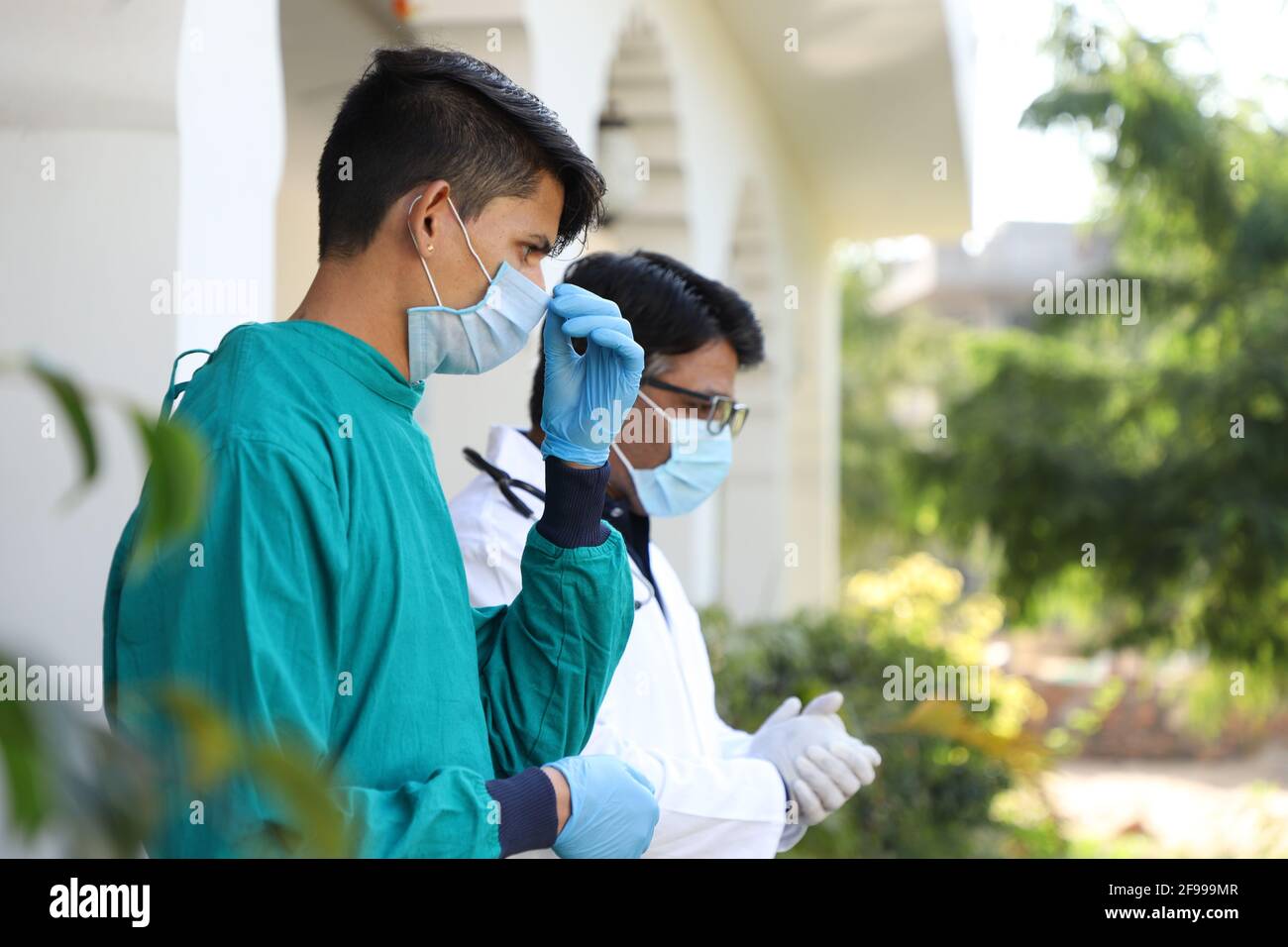 Shallow focus of healthcare workers educating a group of people about ...