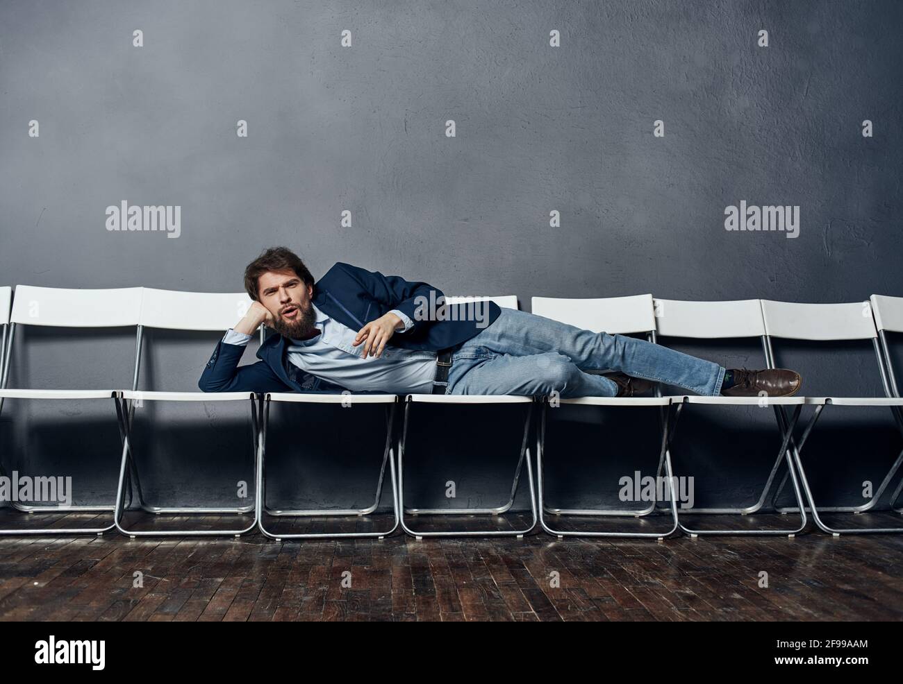 man lying on white chairs work emotions dismissal professional Stock ...