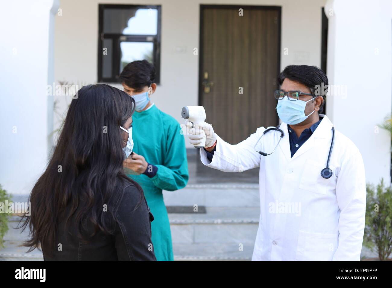 Doctor checking the patients' temperature by the thermometer Stock ...