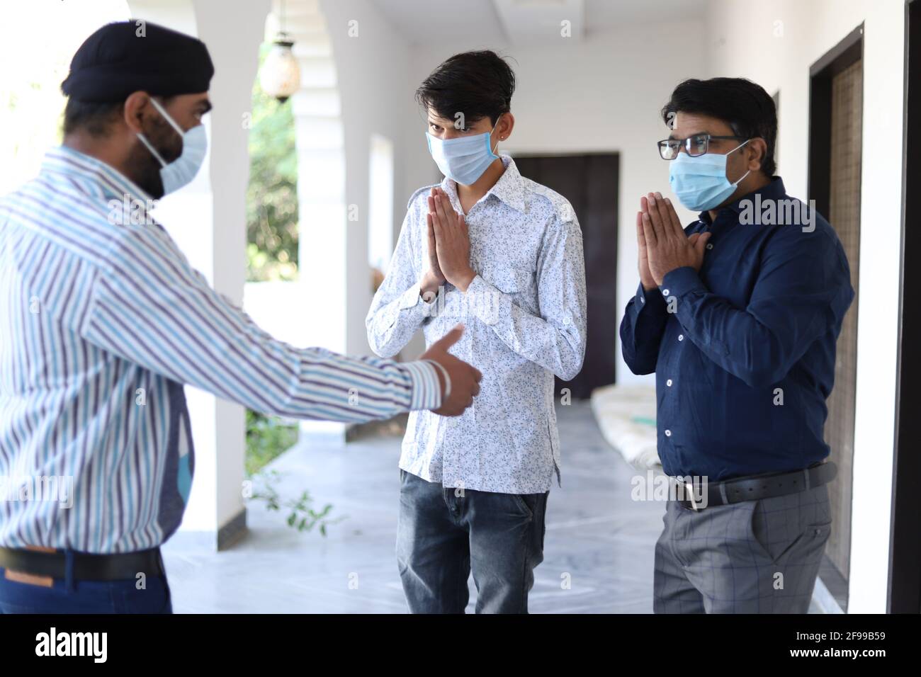Closeup of three Indian men wearing facemasks, talking outdoors Stock ...