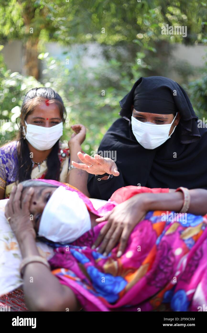 Troubled and upset relatives crying over an ailing elderly in the midst ...