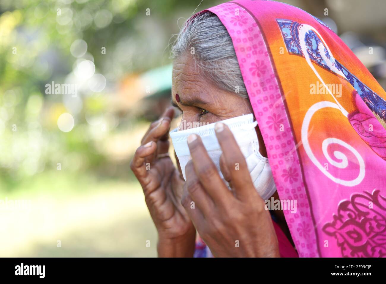 Closeup shot of an Indian woman wearing a white mask Stock Photo - Alamy