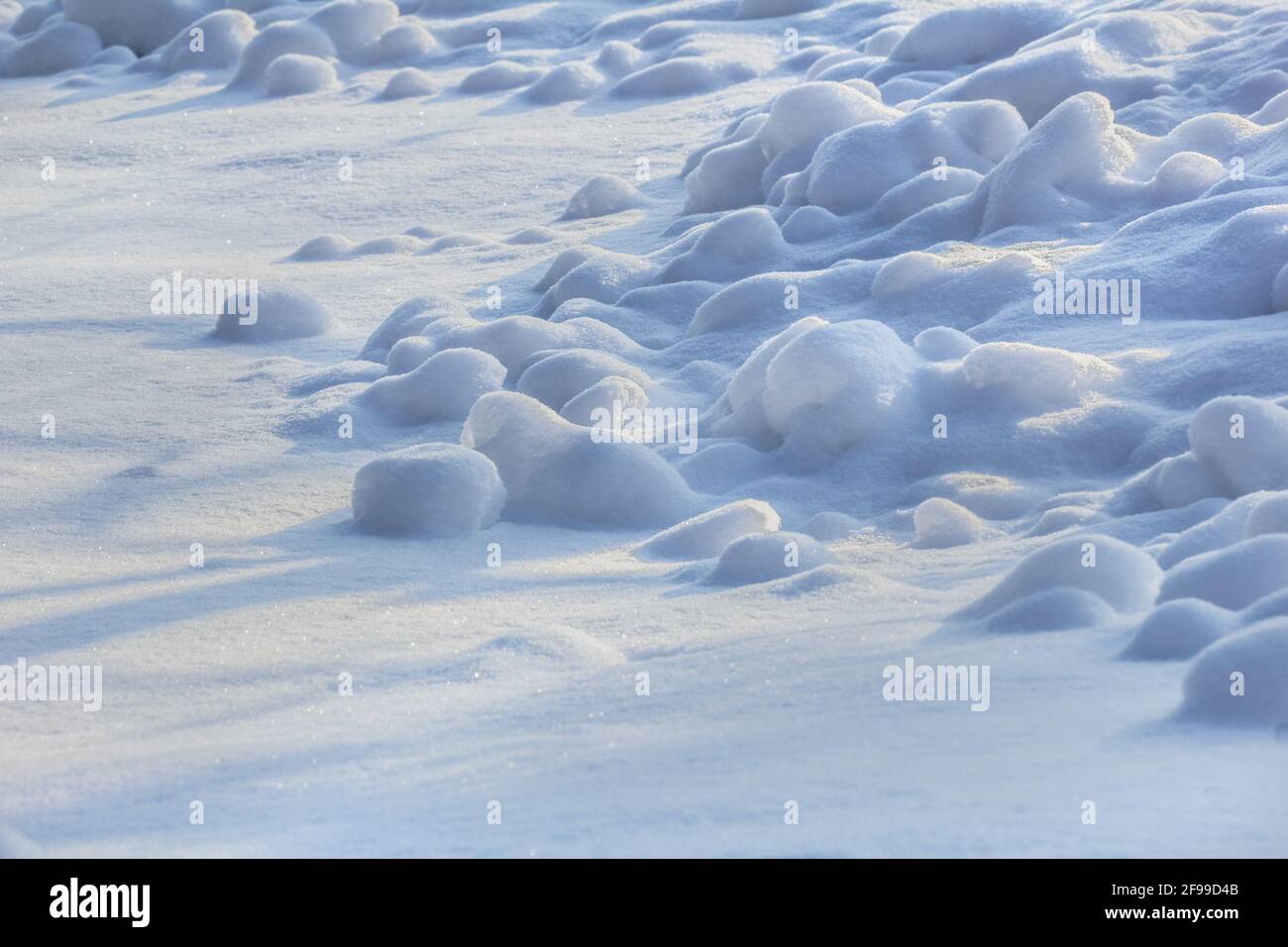 Real natural snow round pieces in cold blue winter day Stock Photo - Alamy