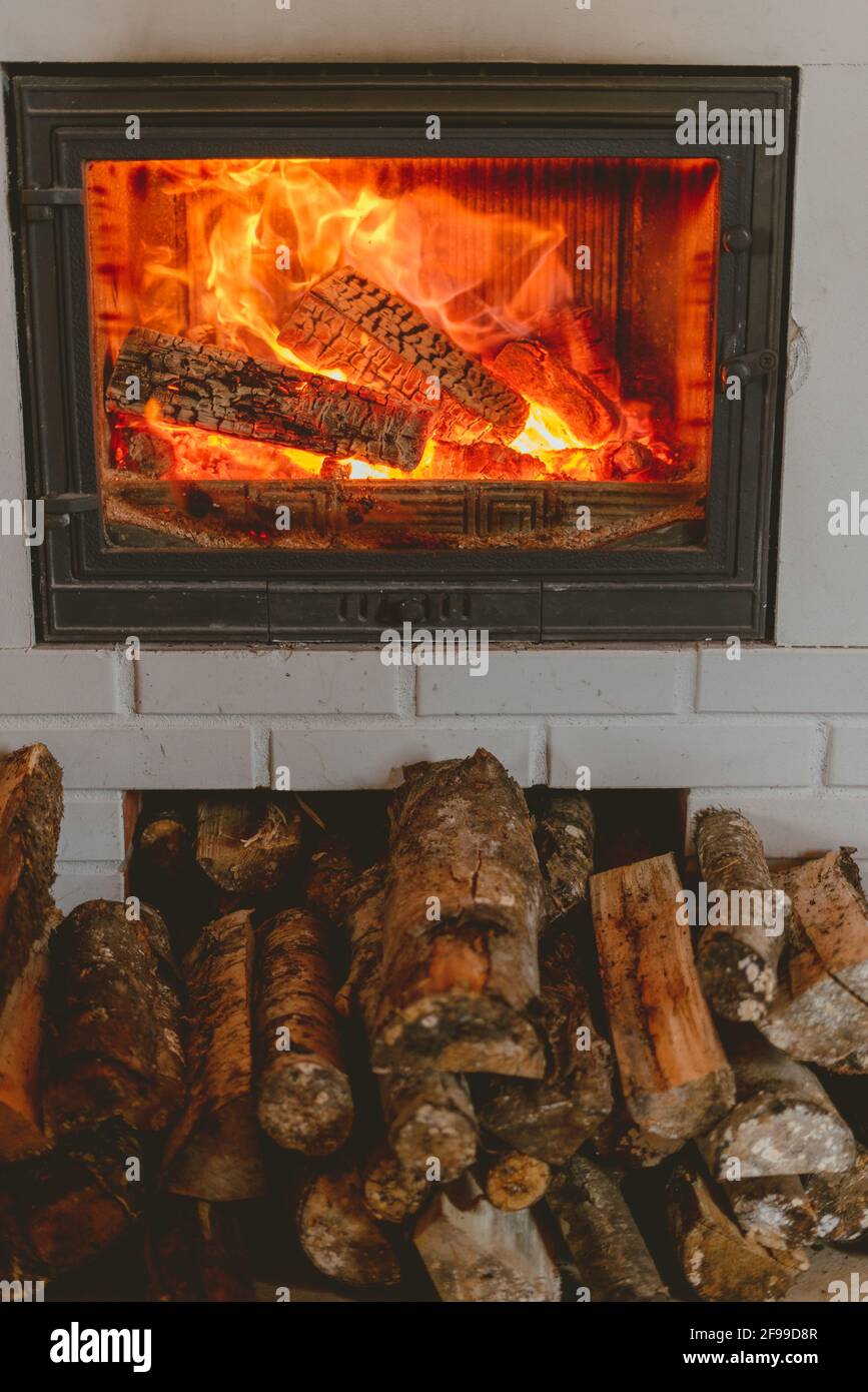 Vertical shot of a fireplace with a stack of dried firewood Stock Photo ...