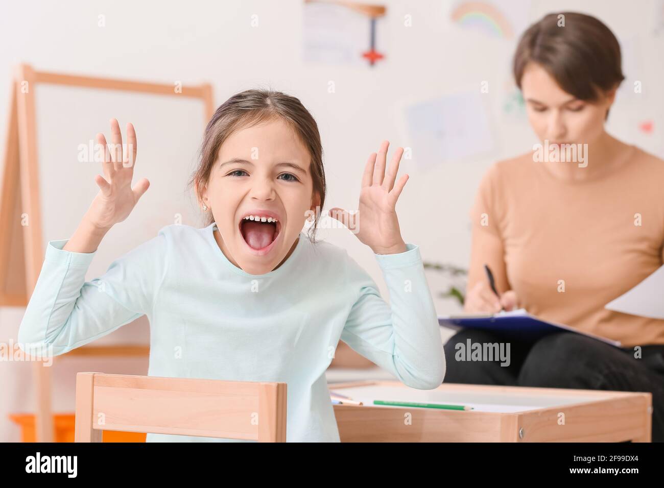 Screaming little girl during psychotherapy session at home Stock Photo ...
