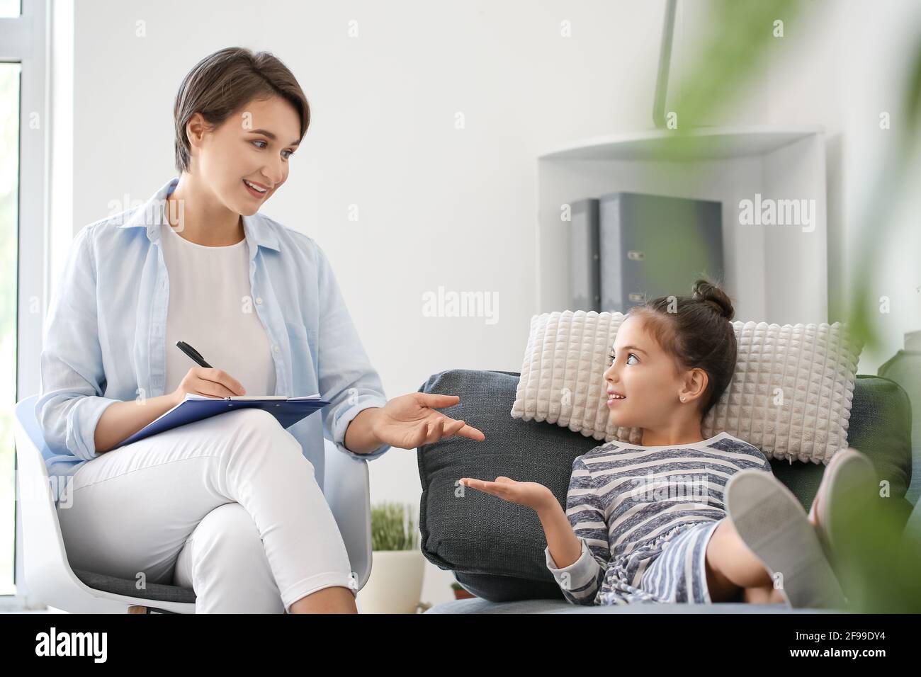 Female psychologist working with little girl in office Stock Photo - Alamy